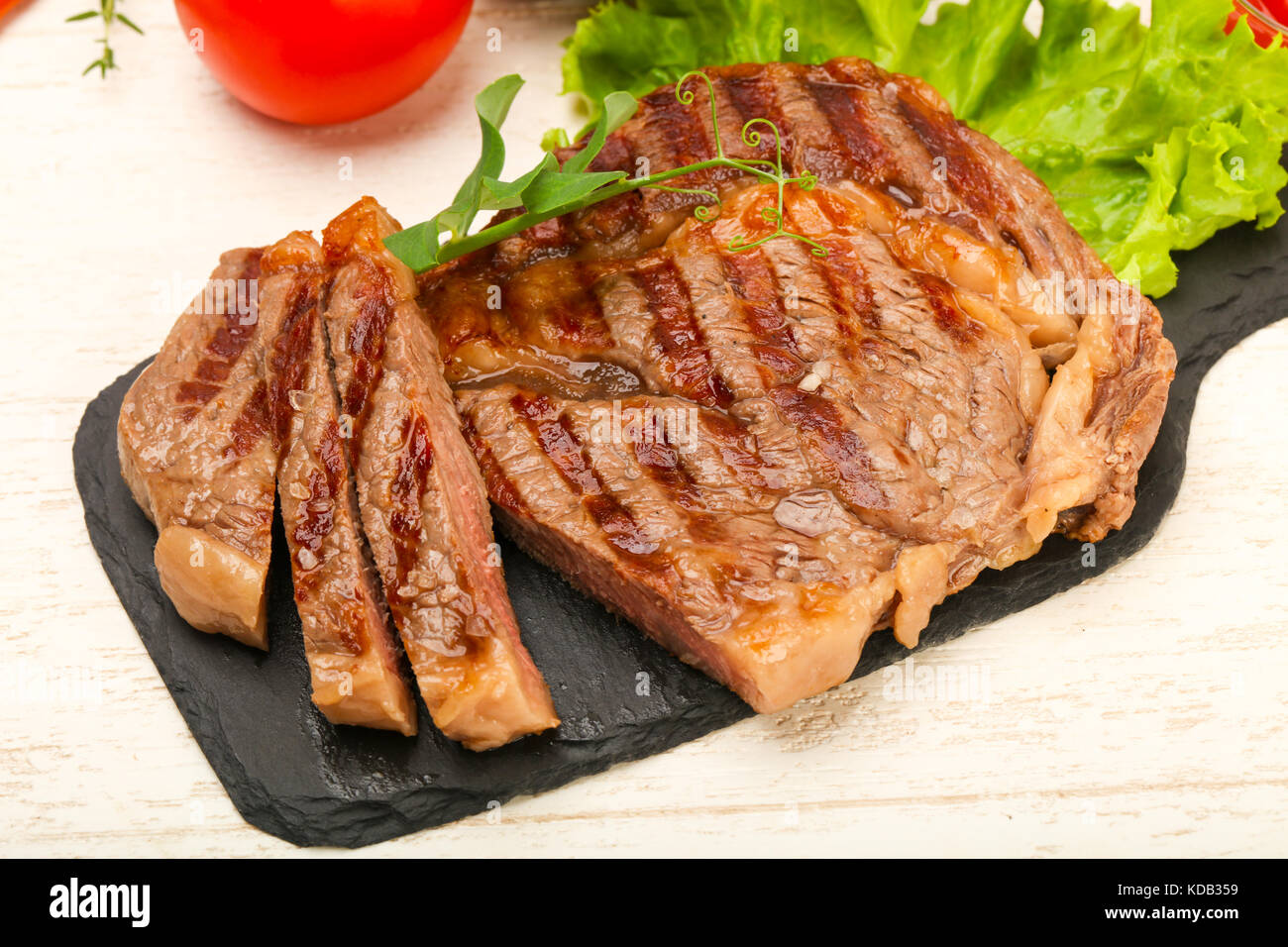 Grilled Rib eye steak with sauce Stock Photo - Alamy