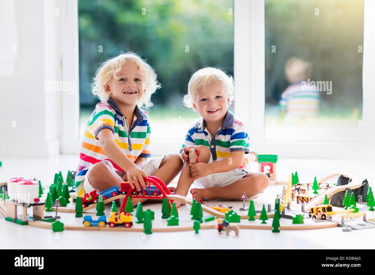 Kids play with toy train railway. Children playing with wooden trains ...