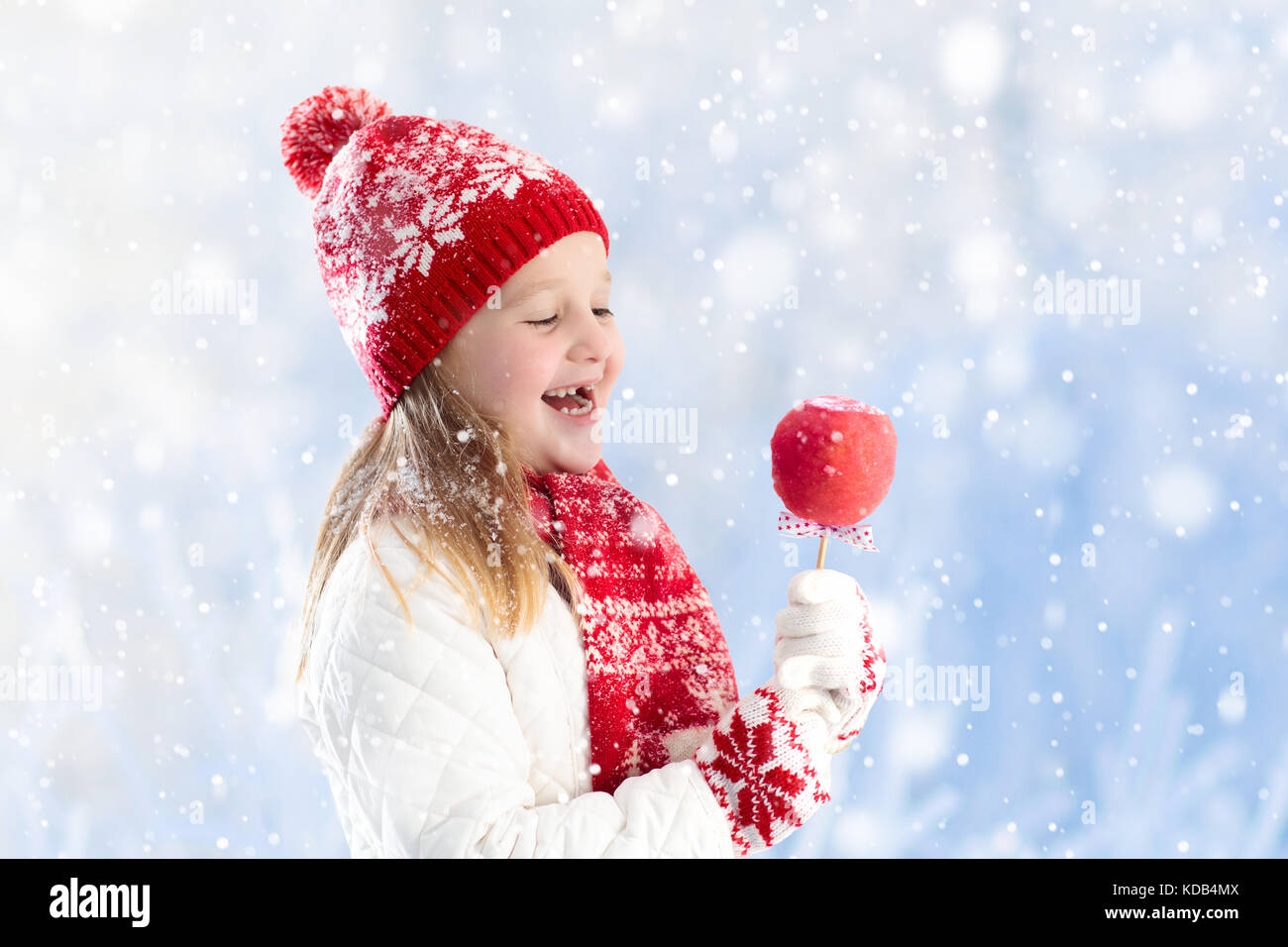 Child eating candy apple on winter fair. Kids eat toffee apples on ...