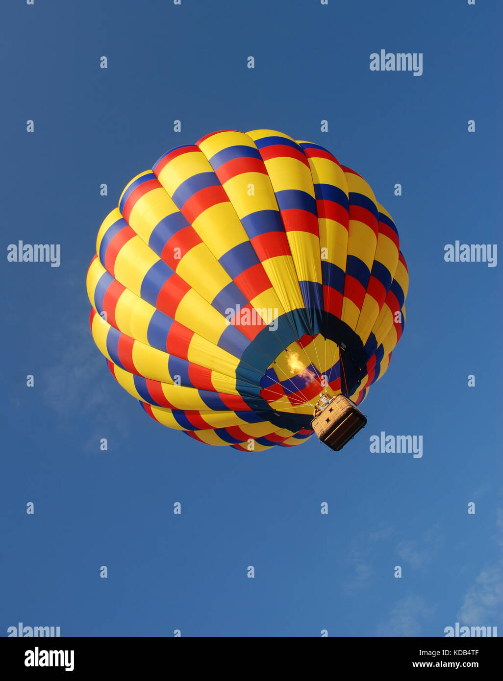 Brightly colored hot air balloon passing overhead Stock Photo - Alamy