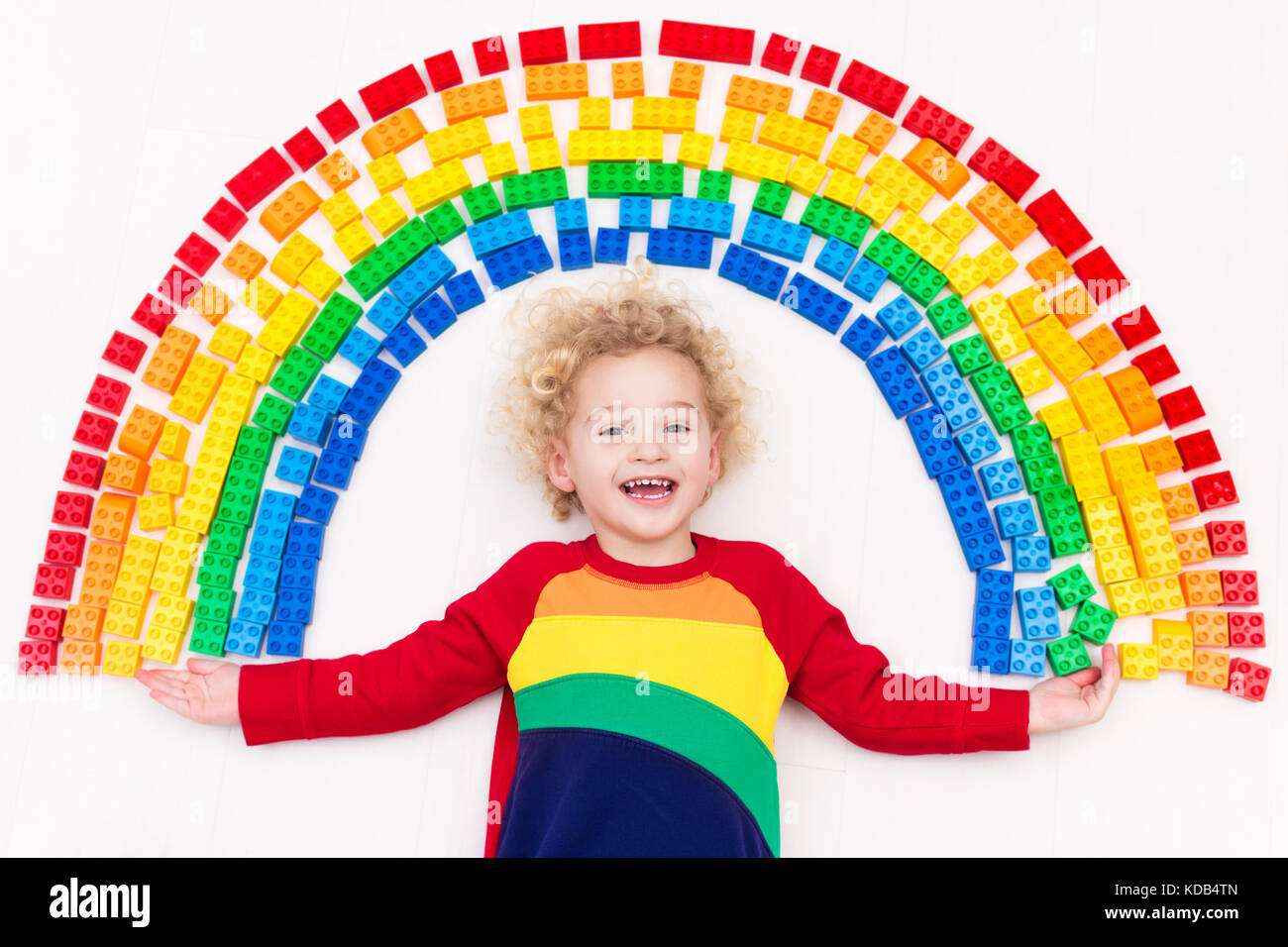 Funny little boy playing with colorful rainbow plastic blocks. Kids ...