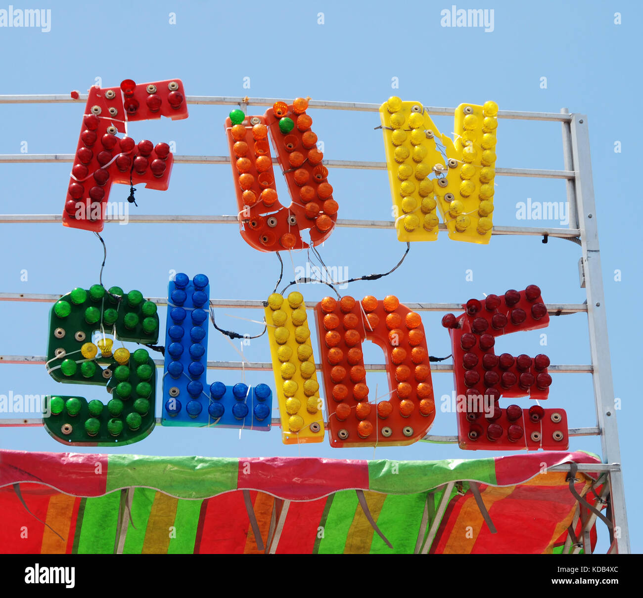 Fun slide sign in outdoor playground with bright colors Stock Photo - Alamy
