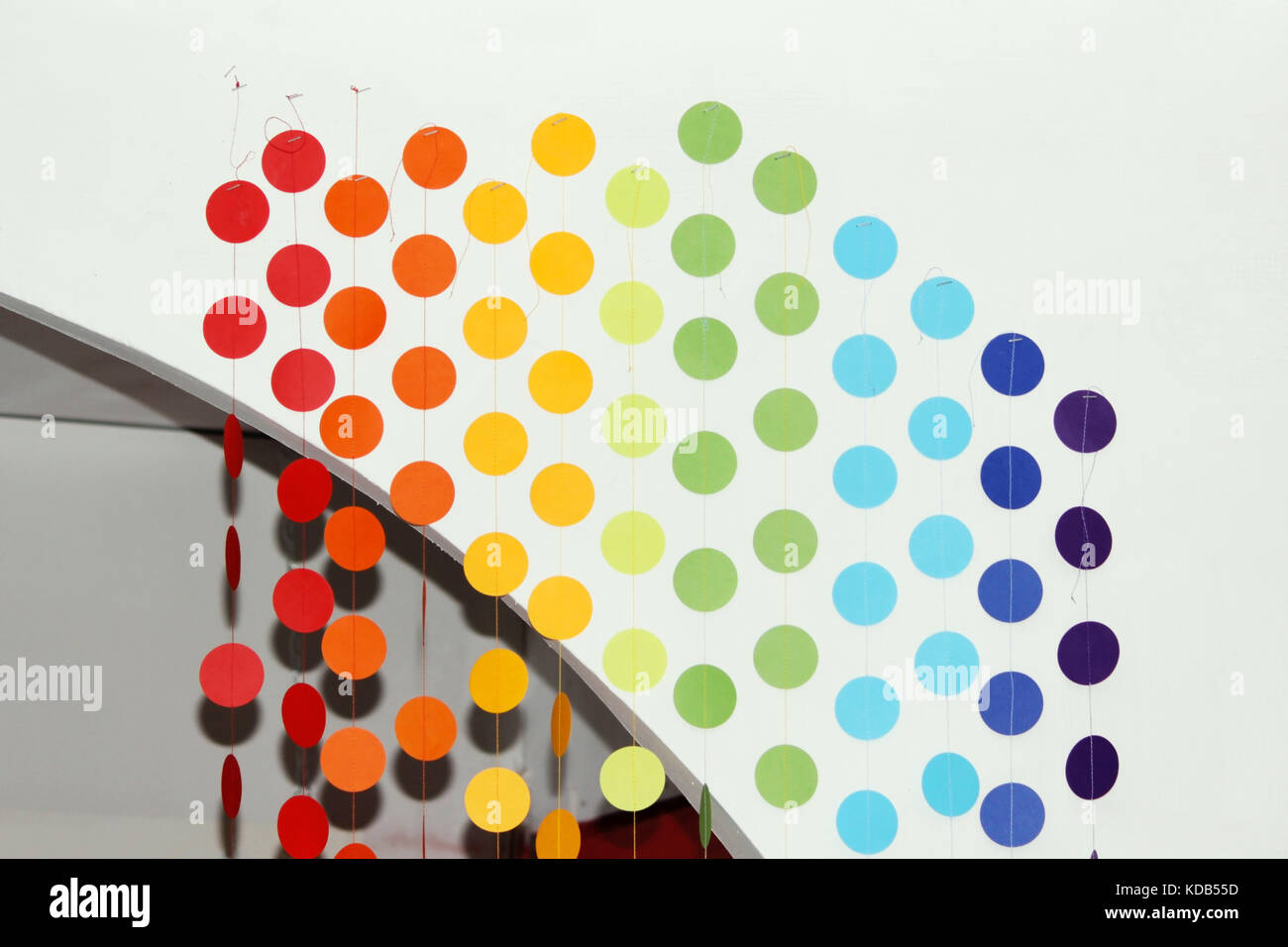 curtain of multi-colored circles suspended on threads and attached to a ...