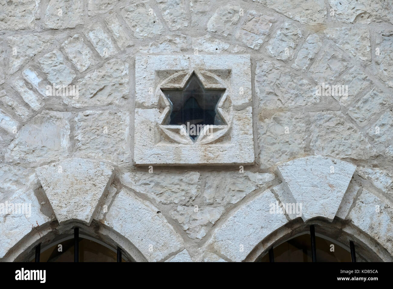 A ventilation window, in the shape of a Star of David, is above two ...