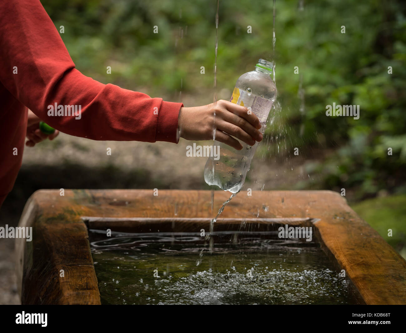 Child filling water bottle hi-res stock photography and images - Alamy
