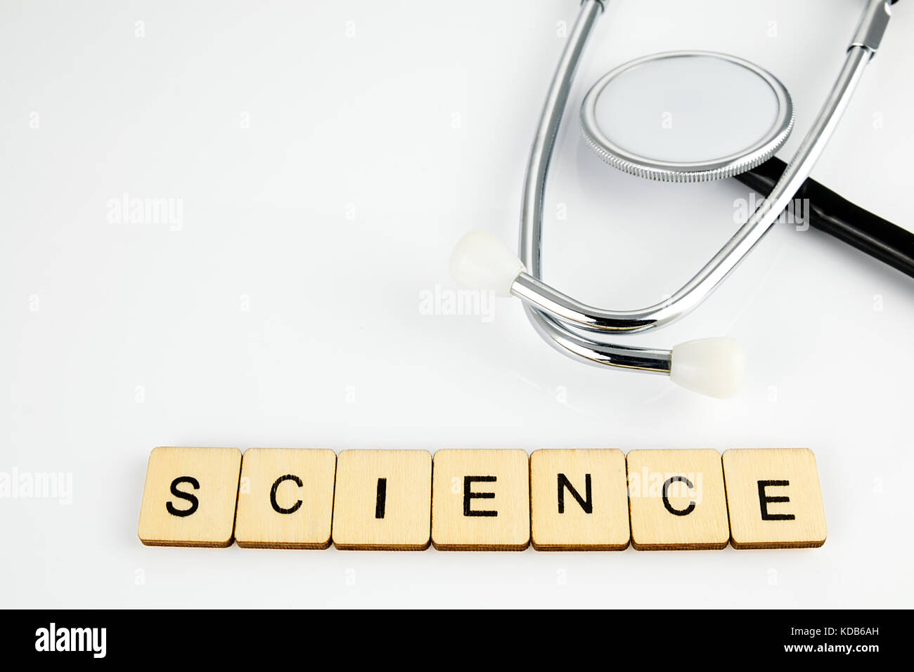 The word science written in letter tiles with a black stethoscope ...