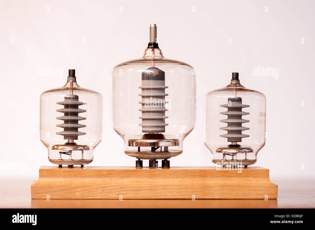 Three old vacuum transmitting tubes in front of a white background ...
