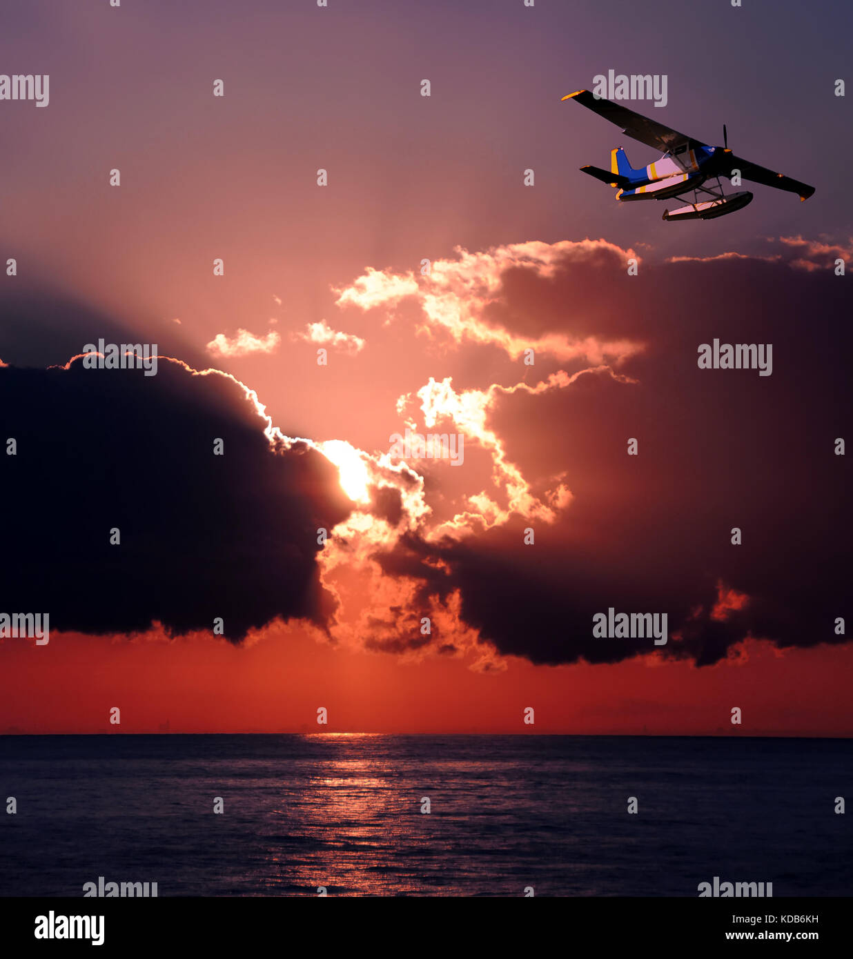 Seaplane soaring over the ocean at sunset Stock Photo - Alamy