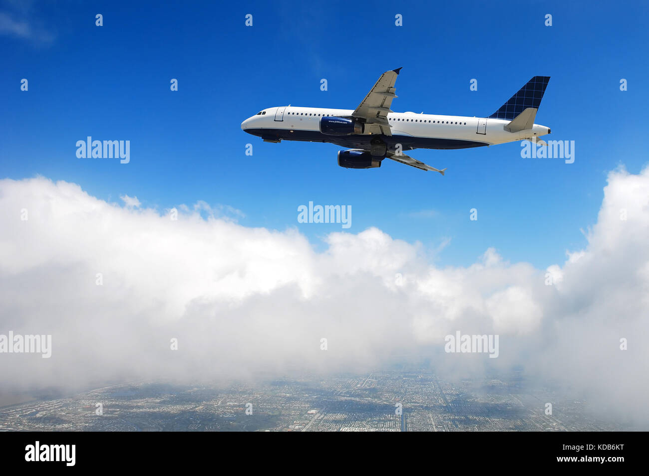 Passenger jet flying above the clouds Stock Photo - Alamy