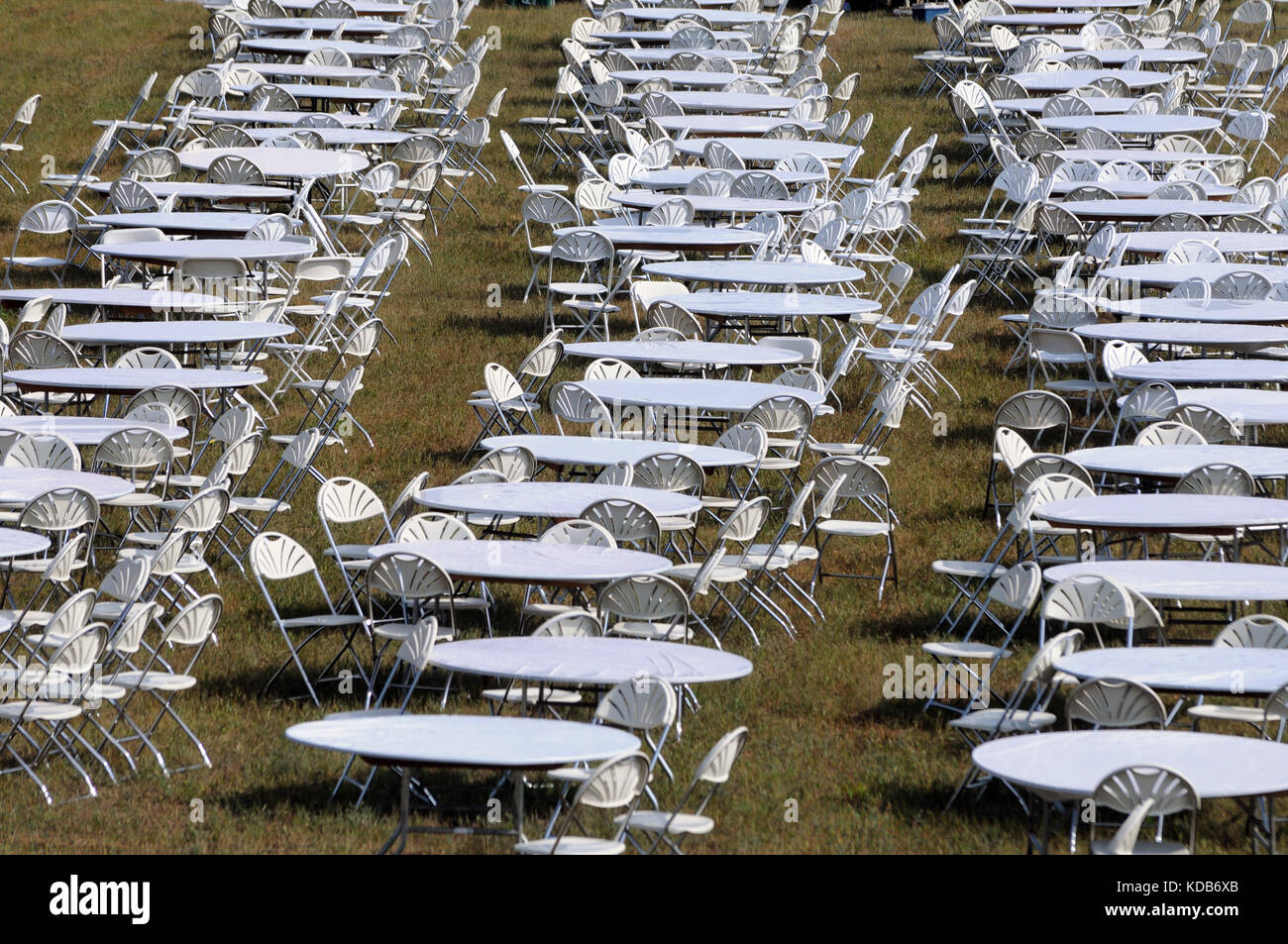 Multitude of empty white tables for outdoor event Stock Photo - Alamy