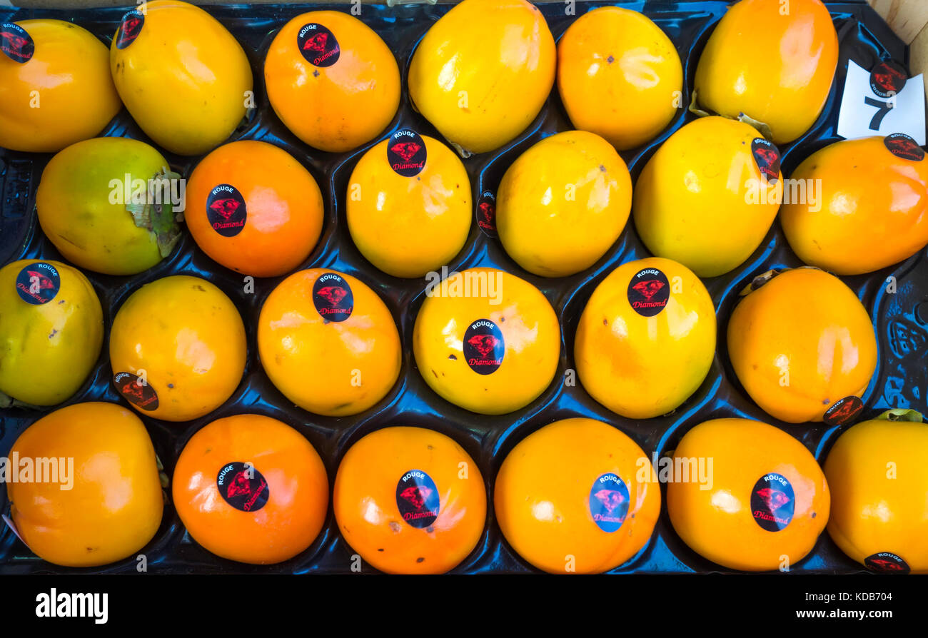 A display of fresh Sharon Fruit in a greengrocers shop Stock Photo - Alamy