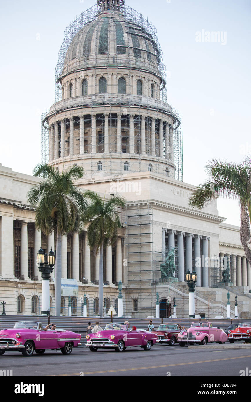 El Capitolio, the capital building of Cuba, and vintage pink cars at ...