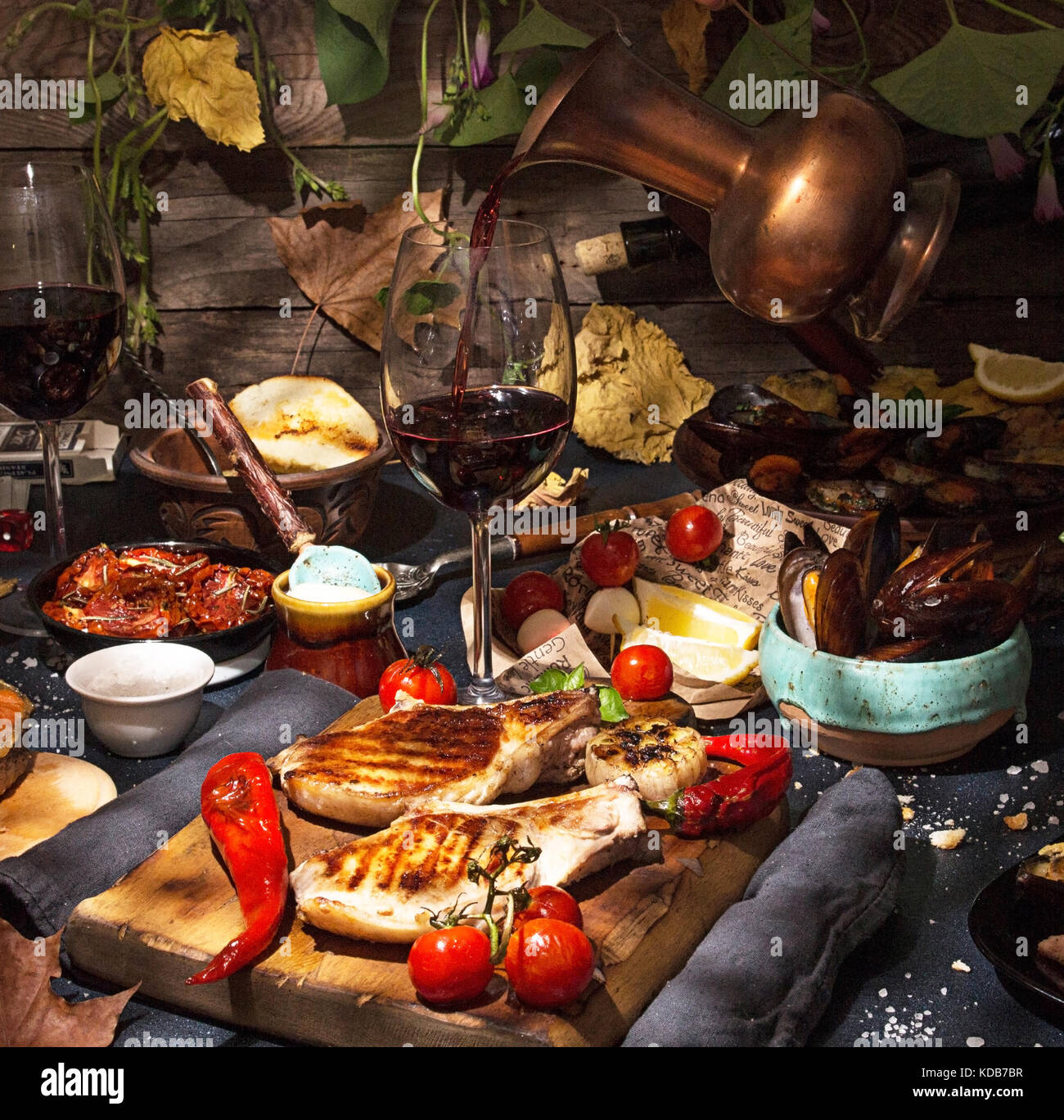 Overhead of dinner table. Assorted grilled barbecue meat and seafood ...