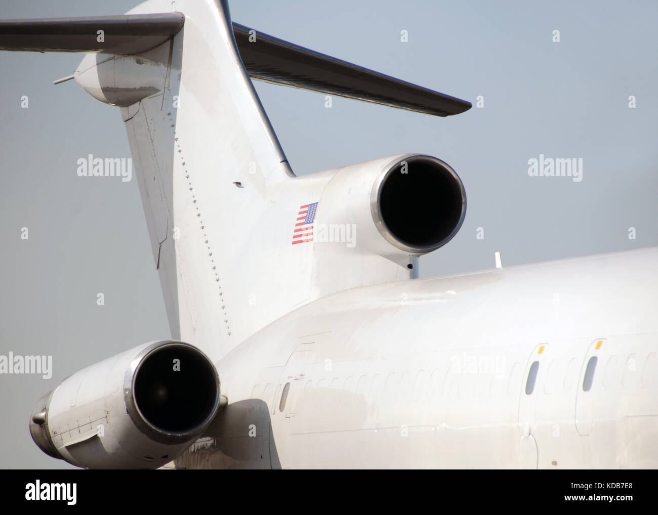 Rear tail section and engines of white jet airplane Stock Photo - Alamy