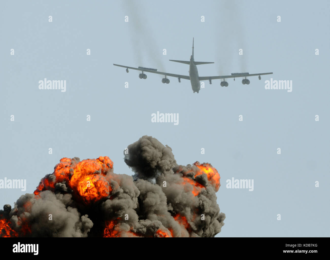 Giant explosions behind heavy US Air Force bomber Stock Photo - Alamy