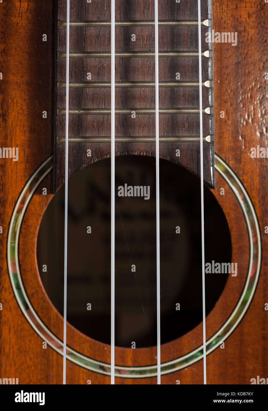Closeup of a small ukulele guitar with strings Stock Photo - Alamy
