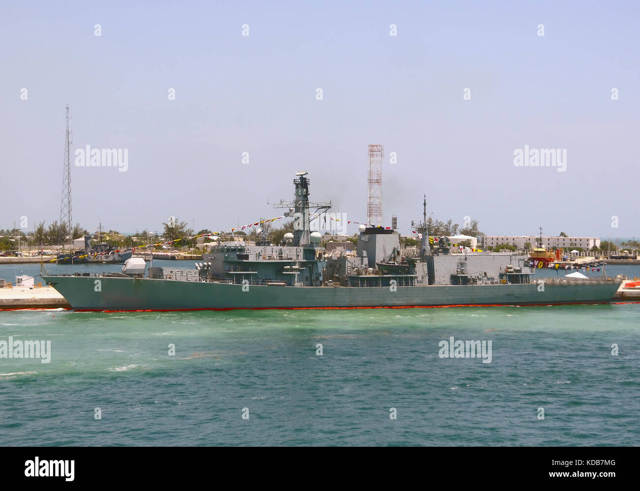 Modern military frigate docked in port Stock Photo - Alamy