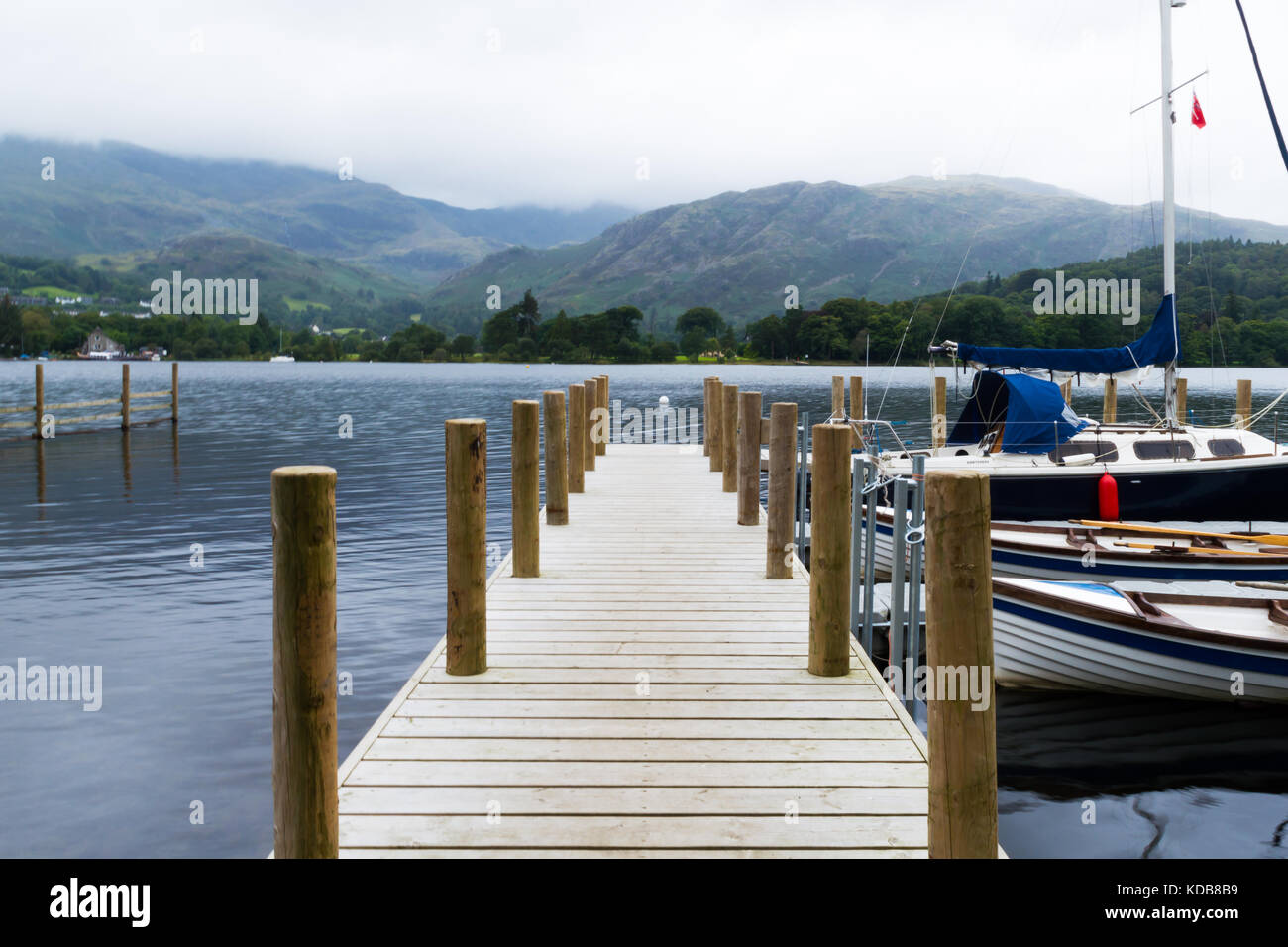 A jetty on Coniston Water on a foggy and misty morning in Coniston ...