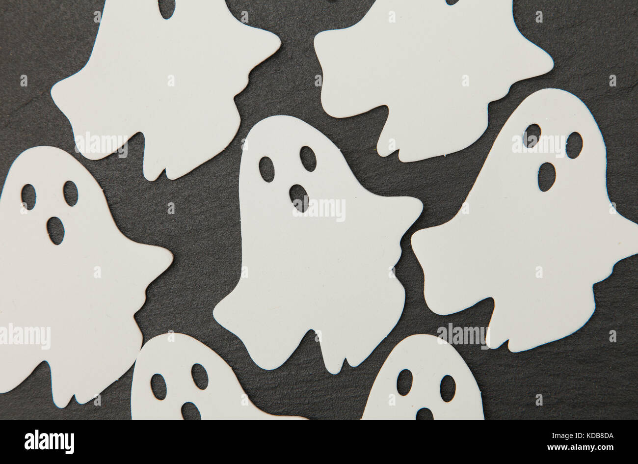 Halloween ghost shapes on a slate background Stock Photo - Alamy