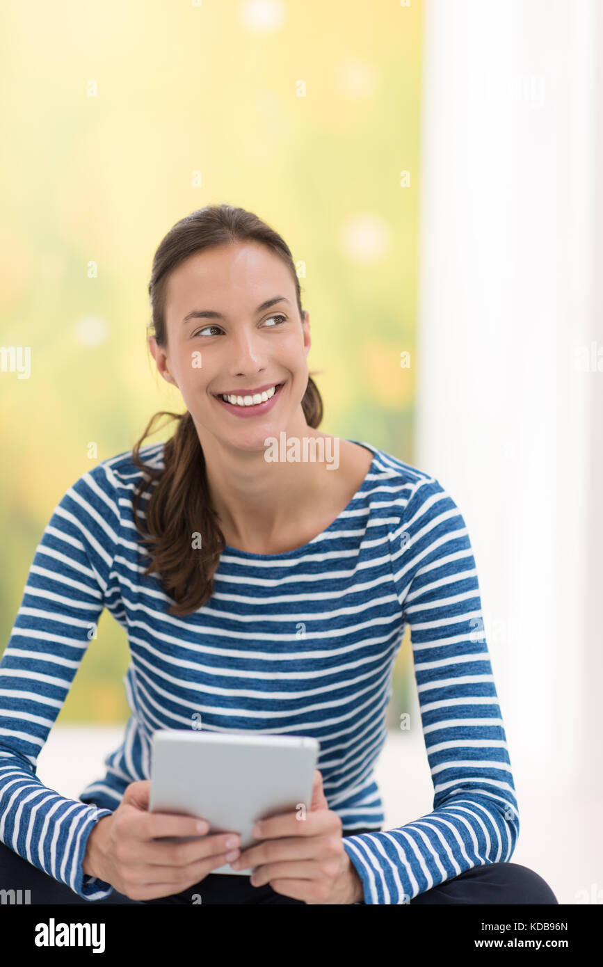 beautiful young women using tablet computer on the floor at home Stock ...