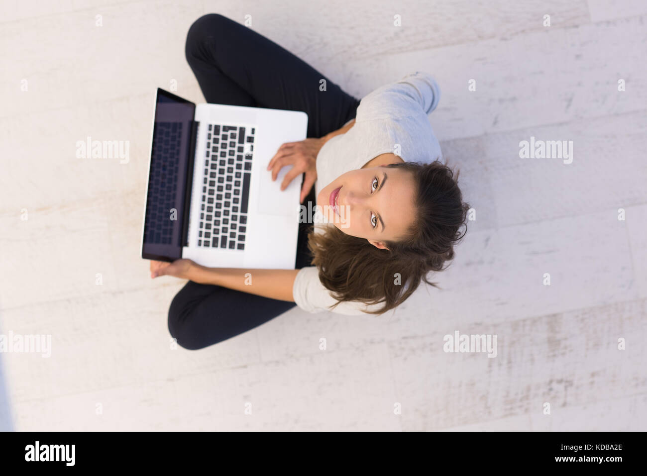 top view of a beautiful young women using laptop computer on the floor ...