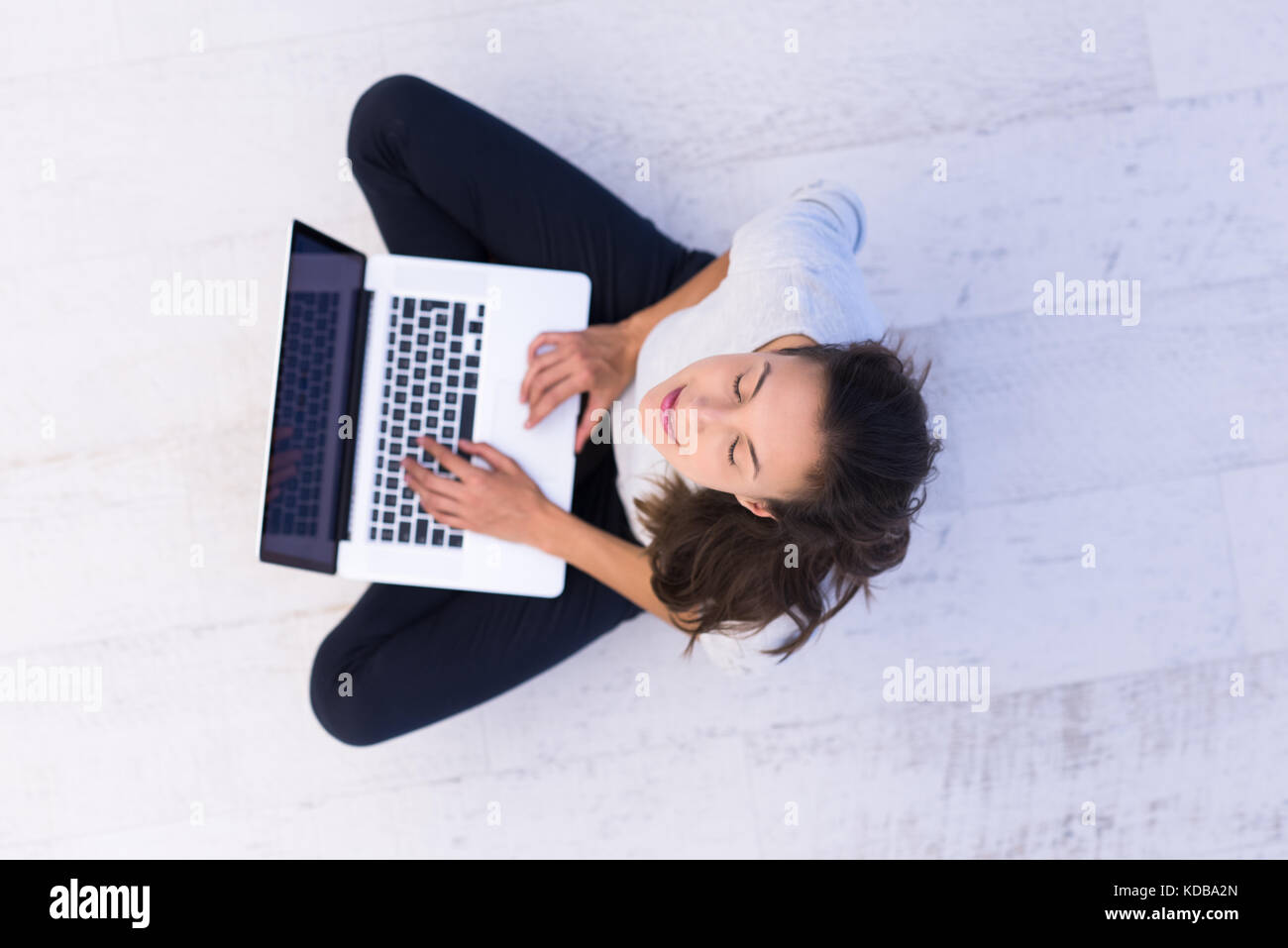 top view of a beautiful young women using laptop computer on the floor ...