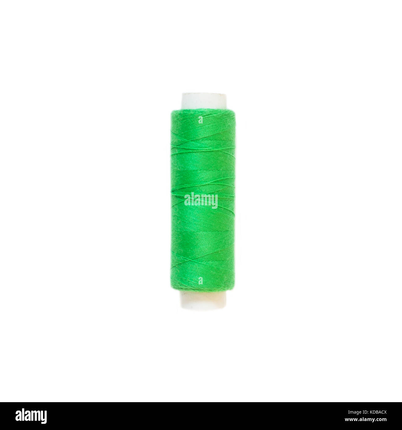 The coil with green threads. White background Stock Photo - Alamy