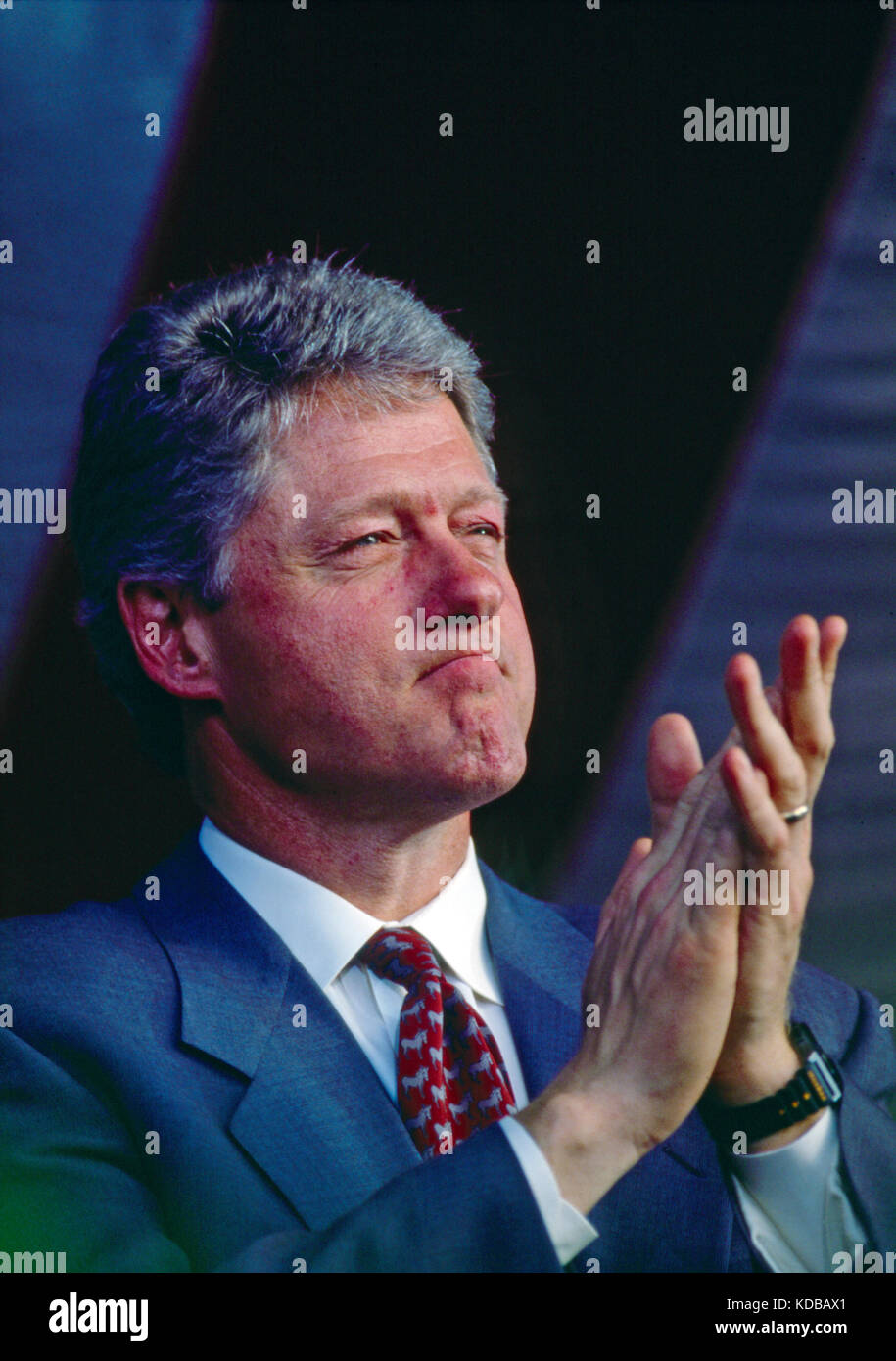 President Bill Clinton speaks in front of a large American flag Stock ...