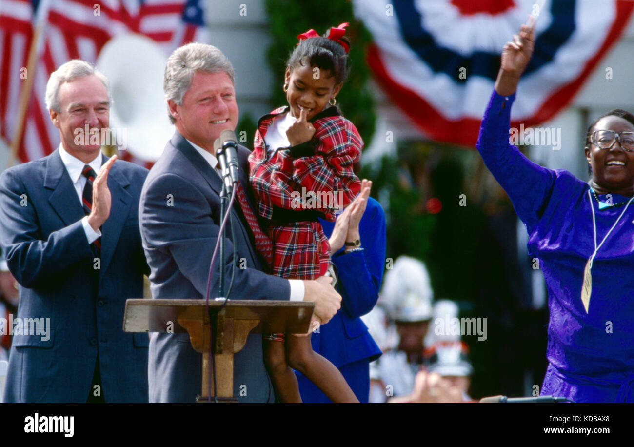 President Bill Clinton lifts an African American child after speaking ...