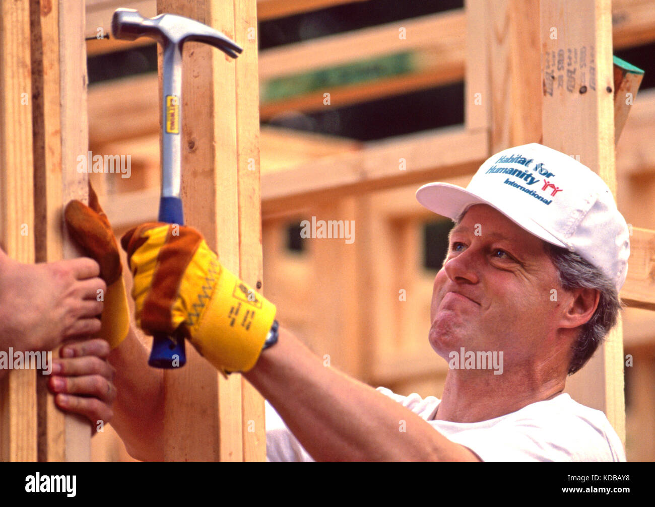 President Bill Clinton works to frame a house during a Habitat for ...