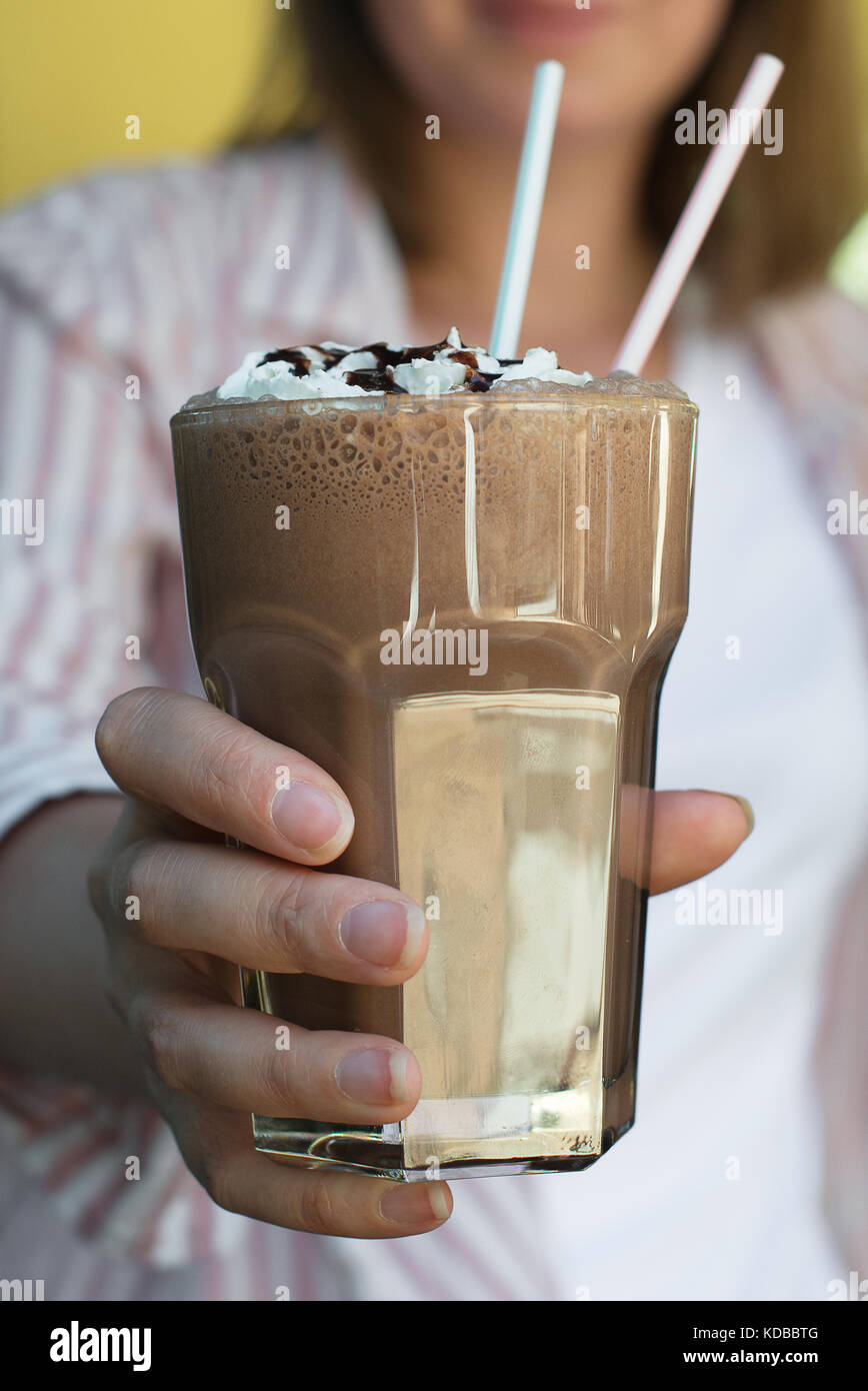 Woman offers a cold chocolate cocktail Stock Photo - Alamy