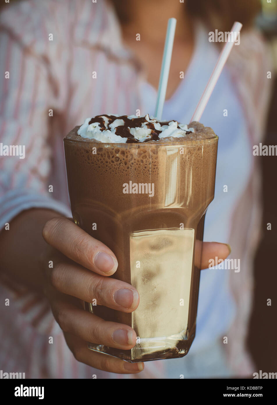 Woman offers a cold chocolate cocktail Stock Photo - Alamy