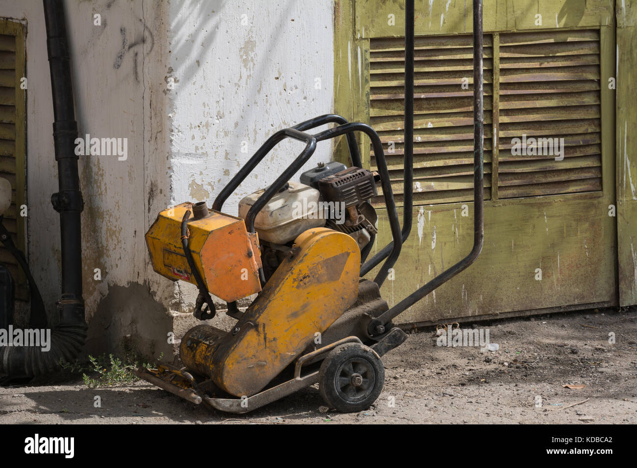 Vibratory plate compactor compacting asphalt at road repair Stock Photo ...