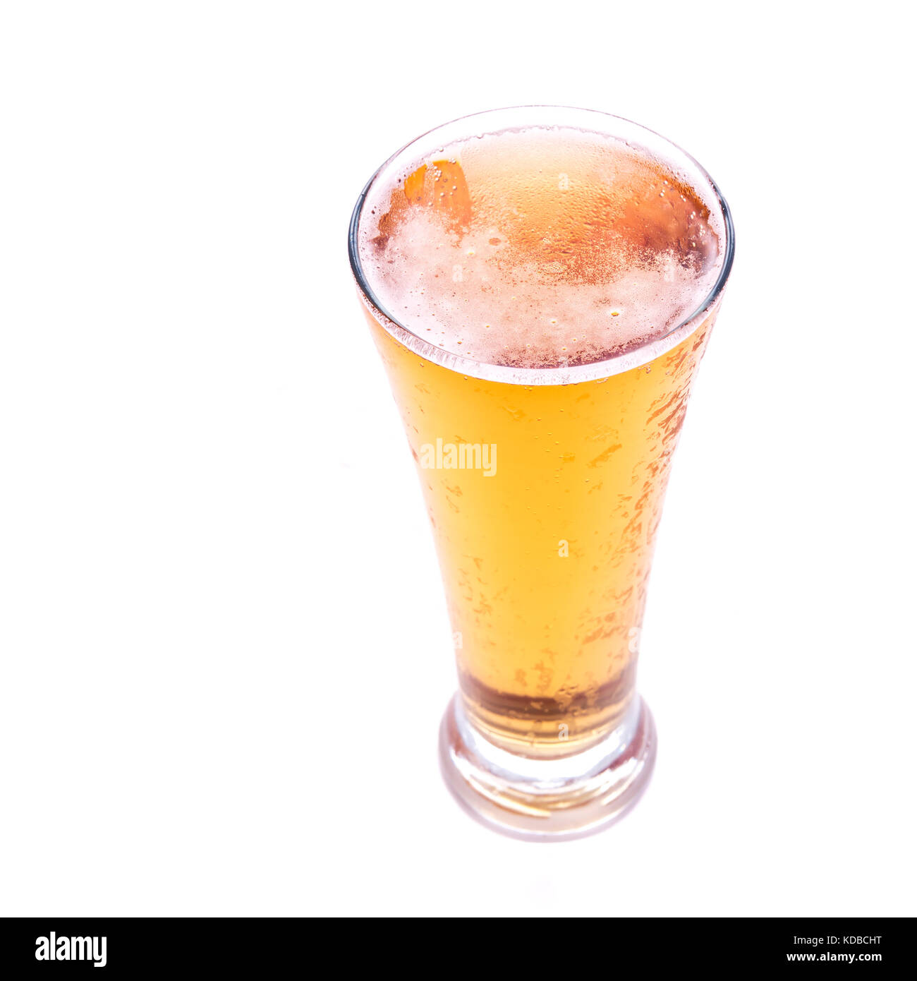 Fresh gold cold and delicious lager beer in glass over white background ...