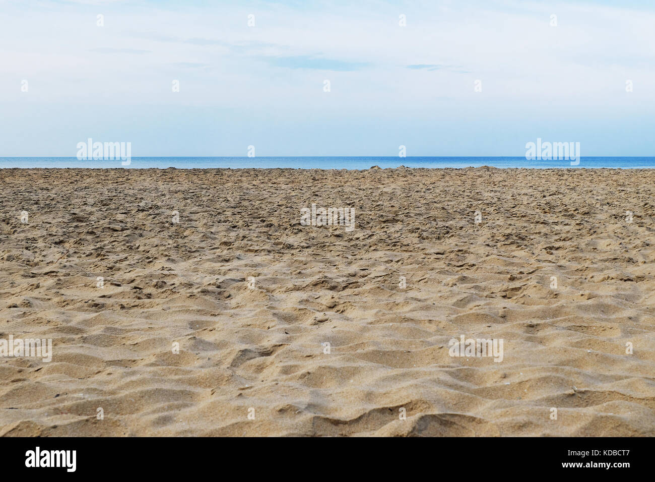 Tattered sandy beach on the Arabian Sea with a thin strip of sea Stock ...
