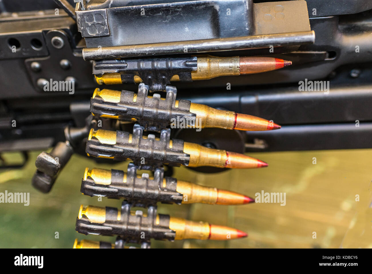 Cartridges in machine-gun belt on diffuse background Stock Photo - Alamy