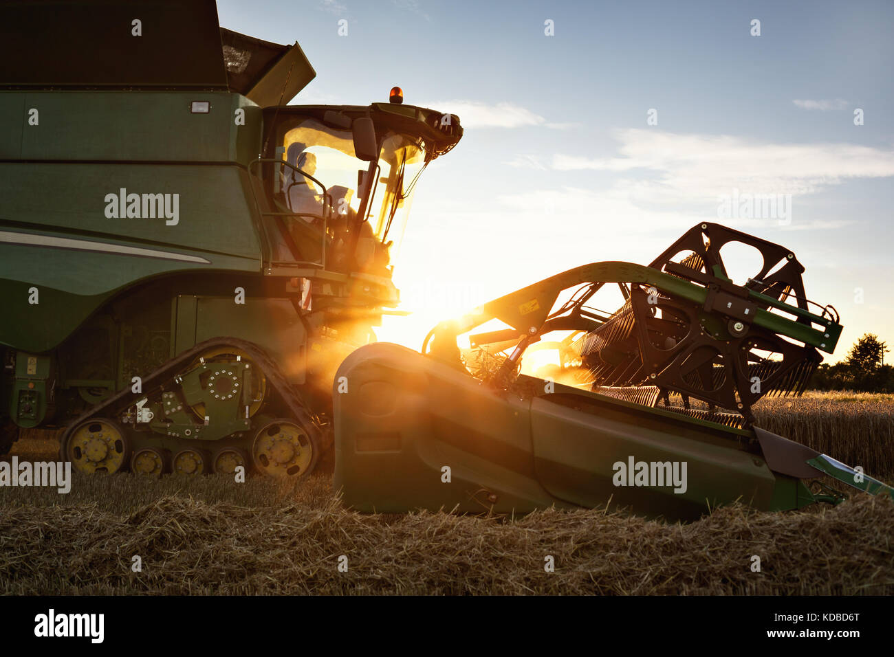 Front part of a combine at sunset Stock Photo - Alamy