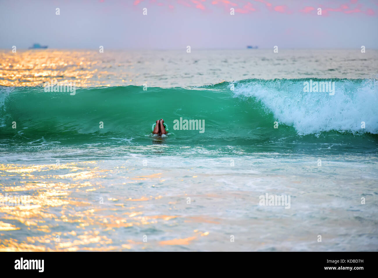 The hands of an unknown lonely floating in the beautiful ocean waves at ...