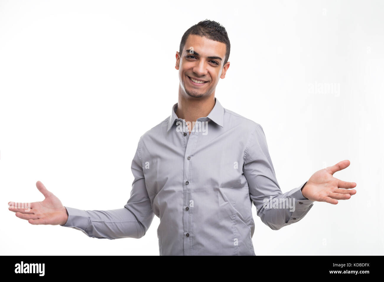 Portrait of young smiling man showing open arms welcoming gesture ...