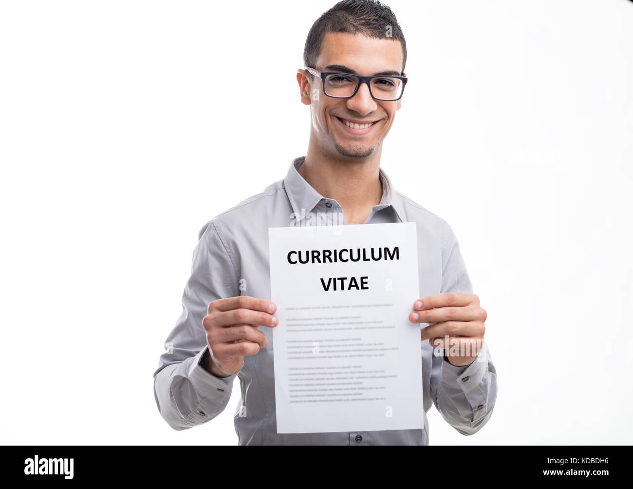 Portrait of young cheerful man standing with curriculum vitae printed ...