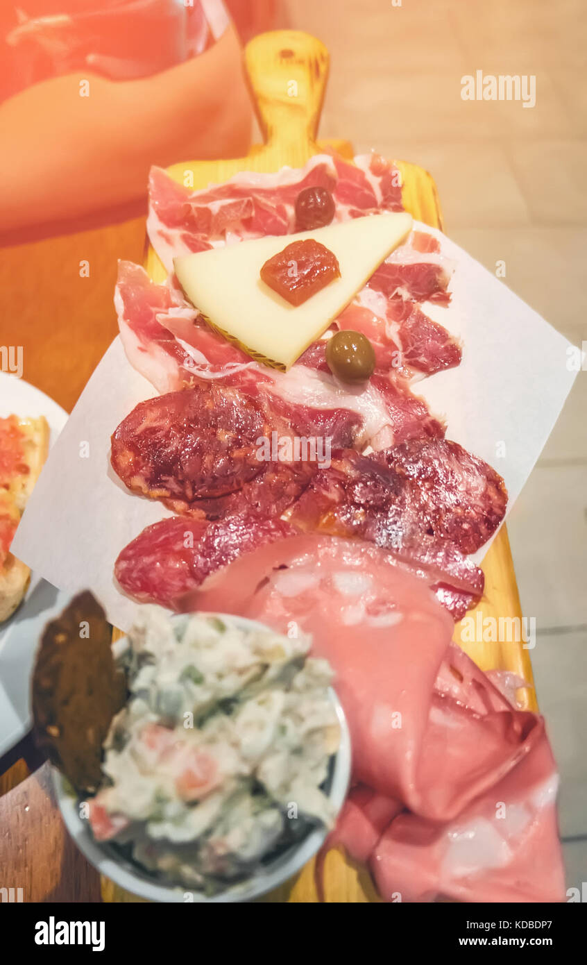 Plate in a cafe with different types of sliced deli meat and cheese ...