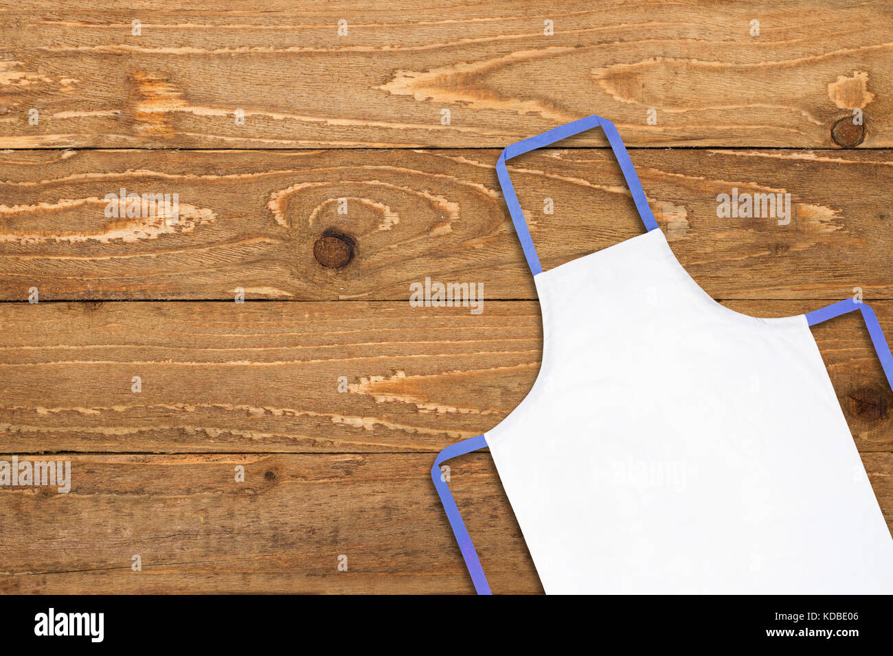 White apron against old wooden texture Stock Photo - Alamy