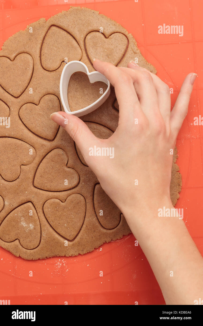 Woman making gingerbread cookie Stock Photo - Alamy