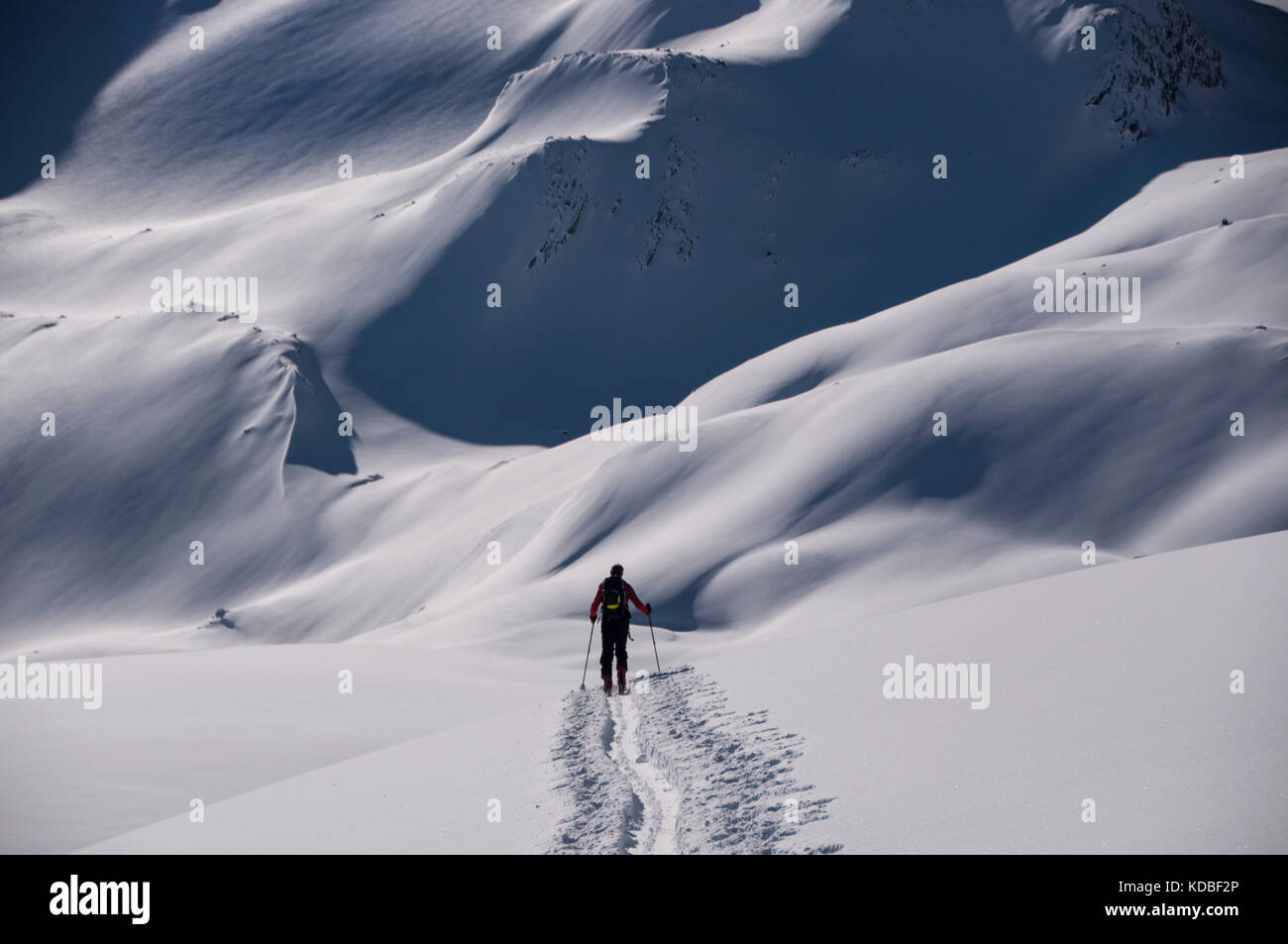 Solo back-country skier ascending towards Mount Baker, Canadian Rockies ...
