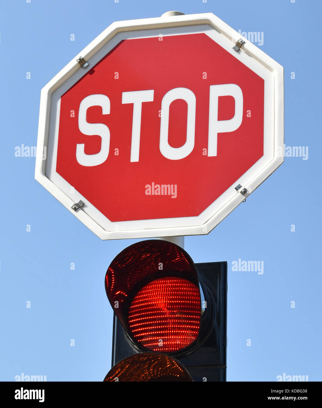 Stop sign and red light at the road crossing Stock Photo - Alamy