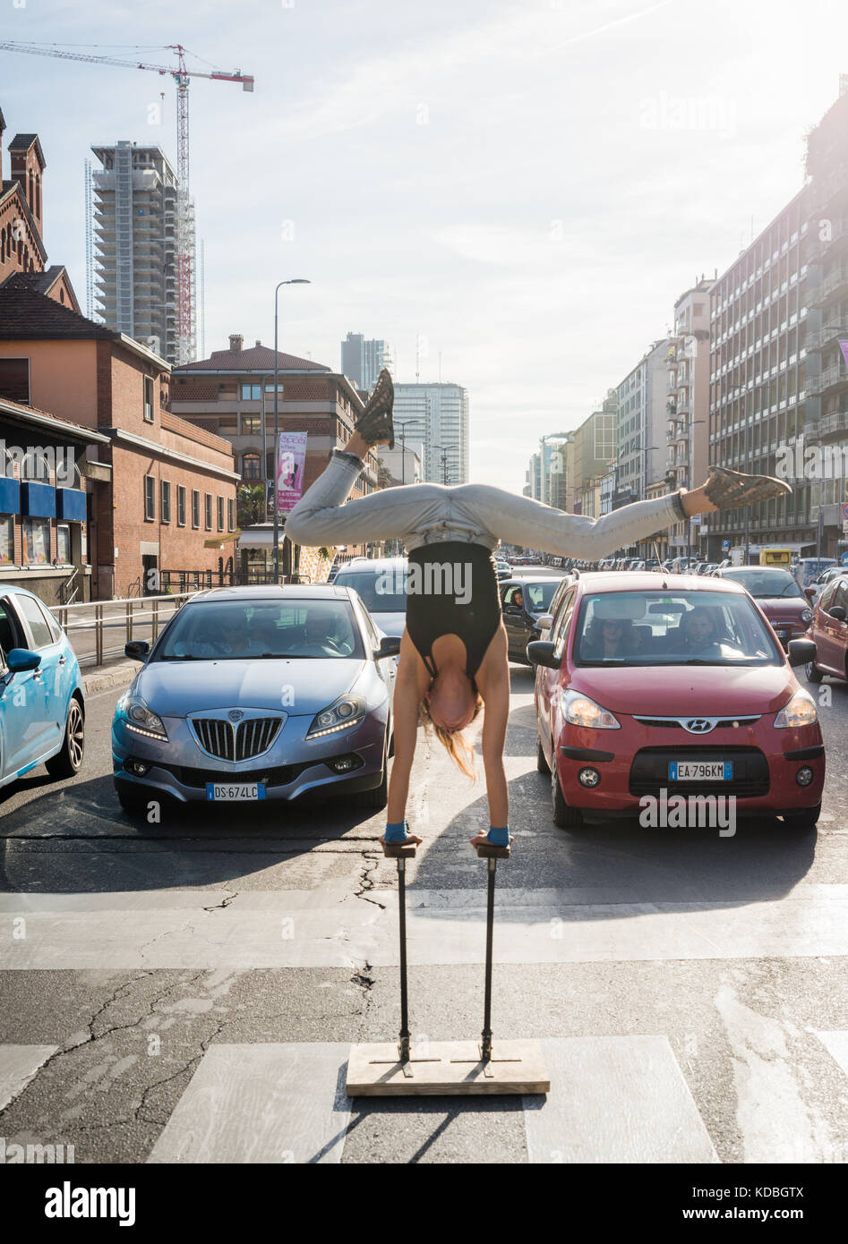 Female street performer on busy road, Milan, Lombardy, Italy Stock ...