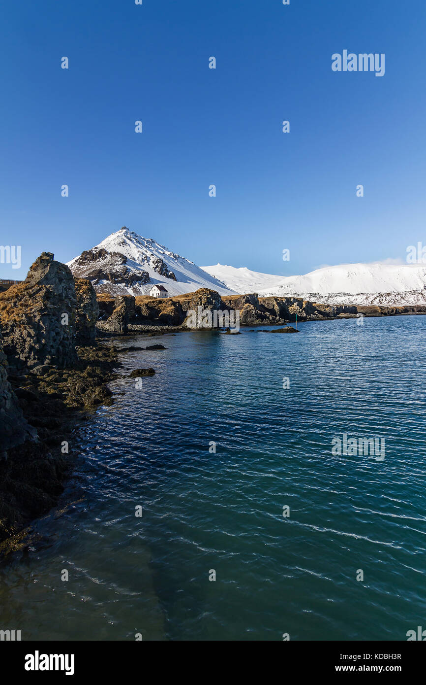 Arnarstapi harbor with Volcano glacier Snaefellsjokull in the ...