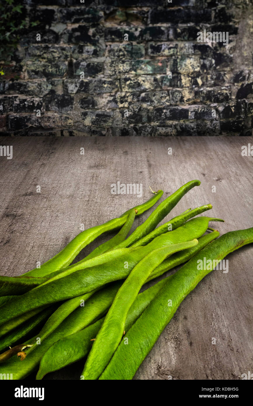 Fresh runner beans on a wooden table Stock Photo - Alamy