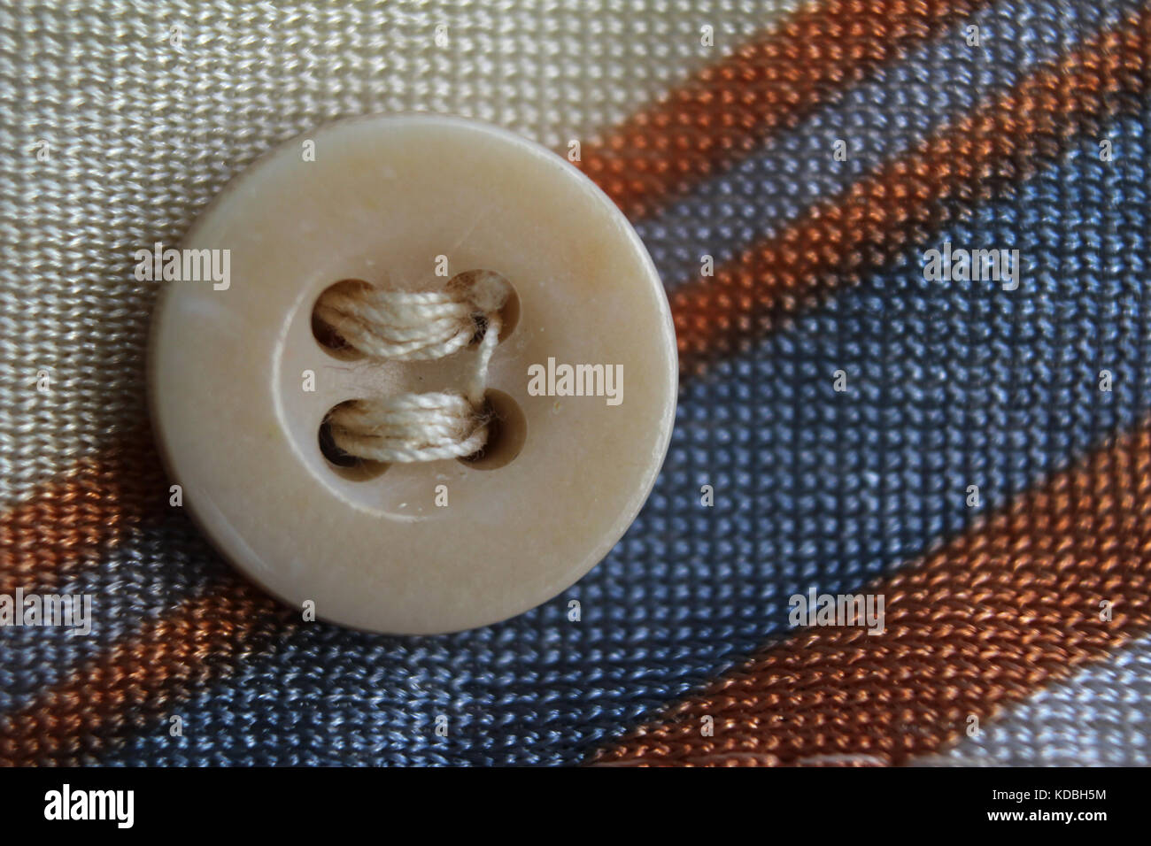 Close-up button of vintage synthetic fabric Stock Photo - Alamy
