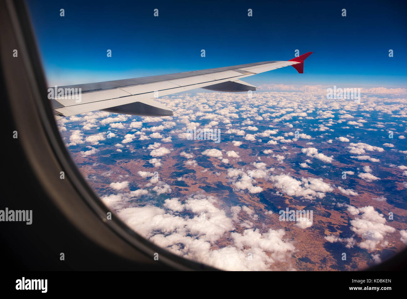 Looking through window aircraft during flight, cloudy sky Stock Photo ...